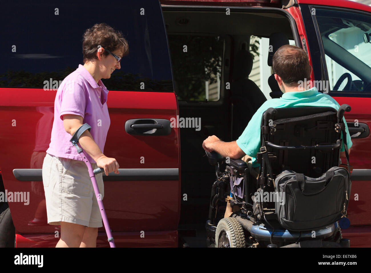 Couple with Cerebral Palsy getting into an adaptive vehicle Stock Photo ...