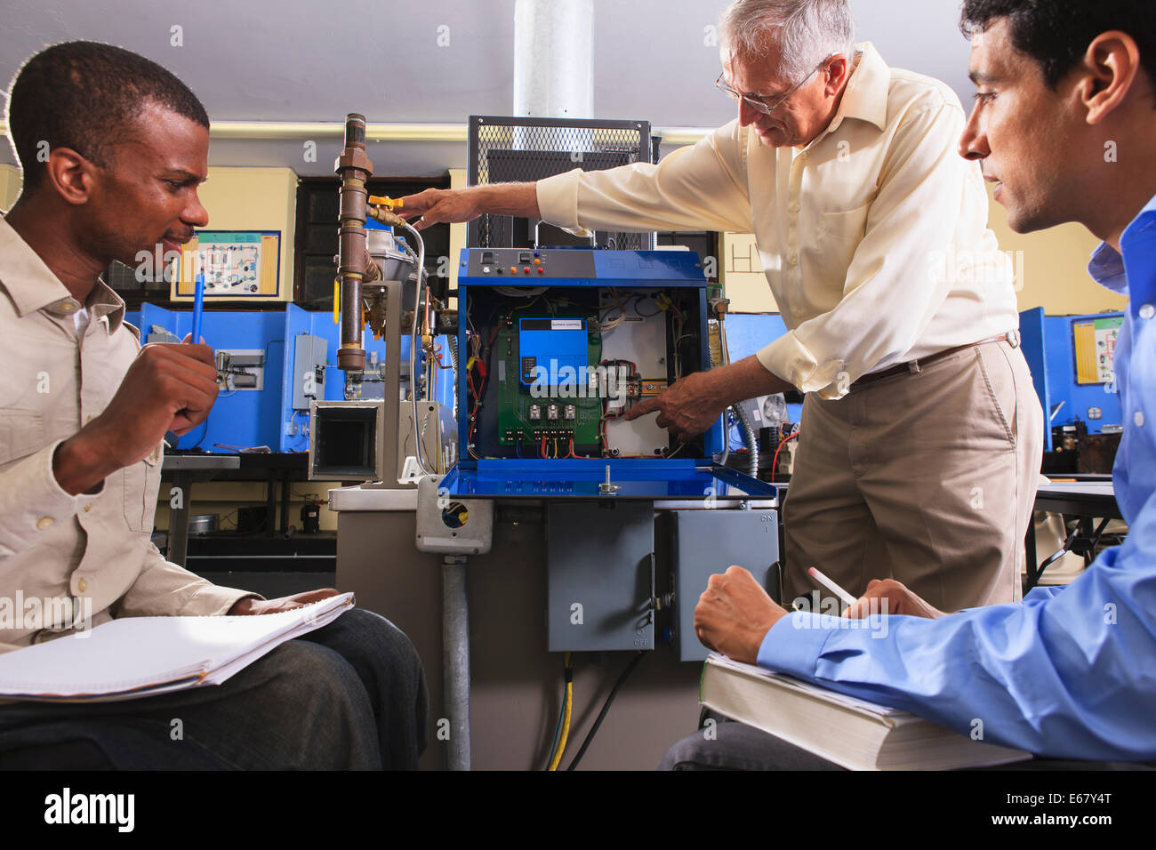Professor demonstrating furnace electronic control system in HVAC ...