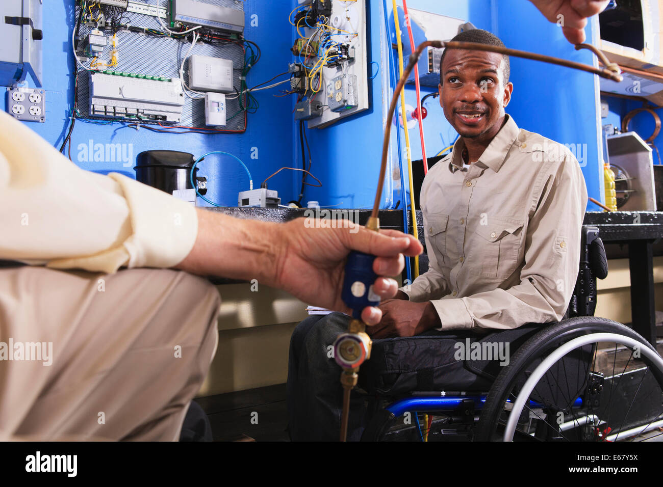 Instructor demonstrating air conditioner high pressure line to student ...