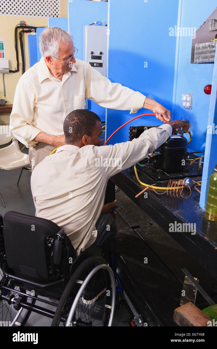 Instructor discussing air conditioner recharging with student in ...