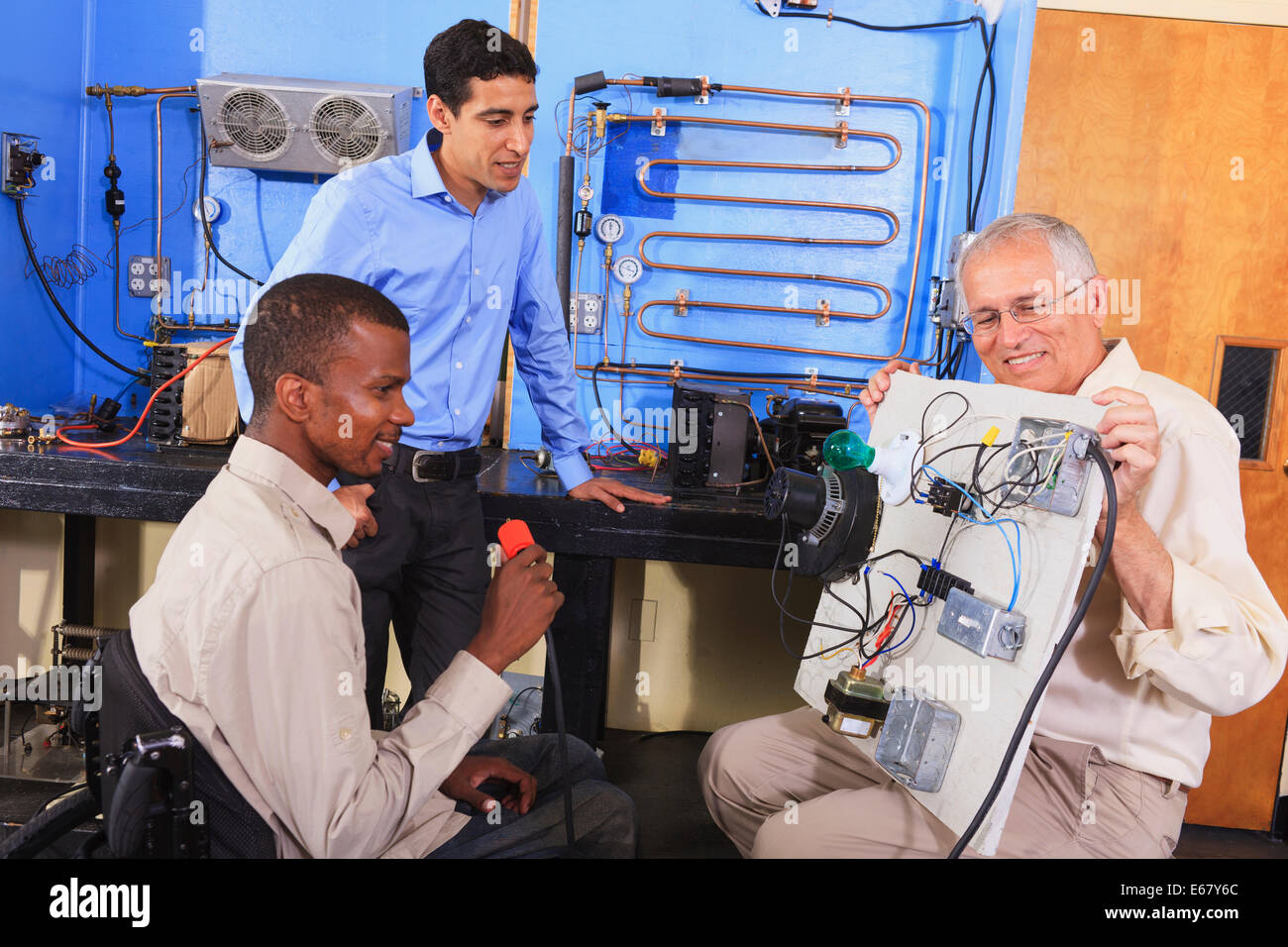 Instructor demonstrating air conditioner control system on demo board ...