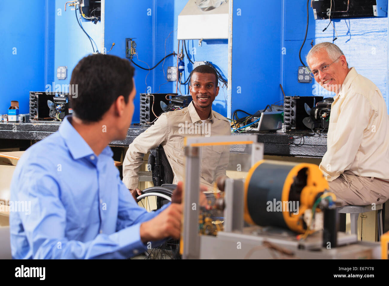 Student setting up generator experiment while instructor discusses HVAC ...