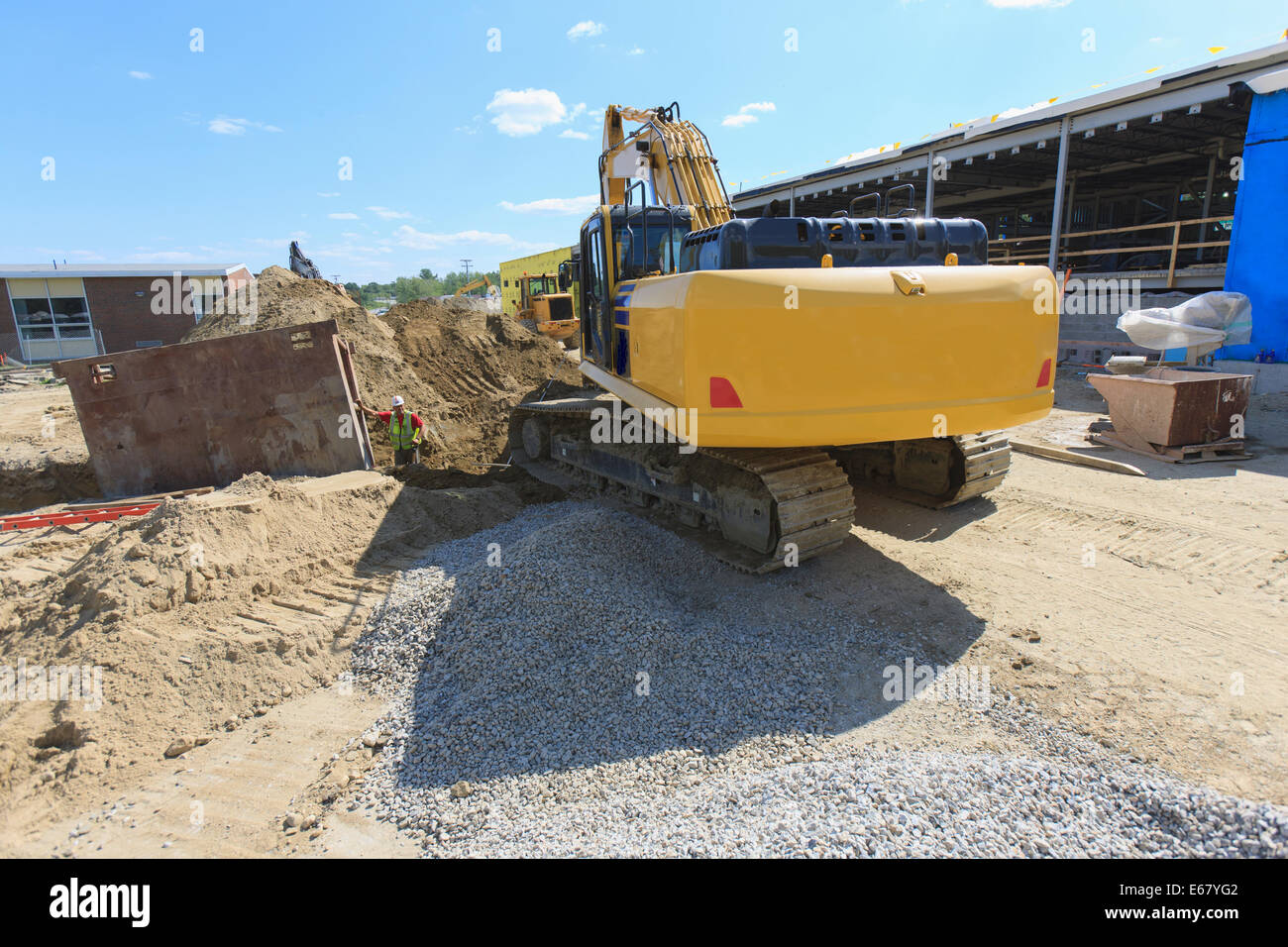 Excavator and trench shield for construction workers at building site ...