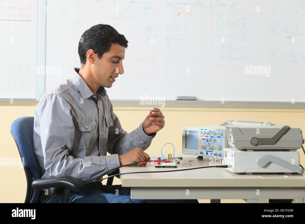 Engineering student preparing prototyping breadboard for an electronics ...