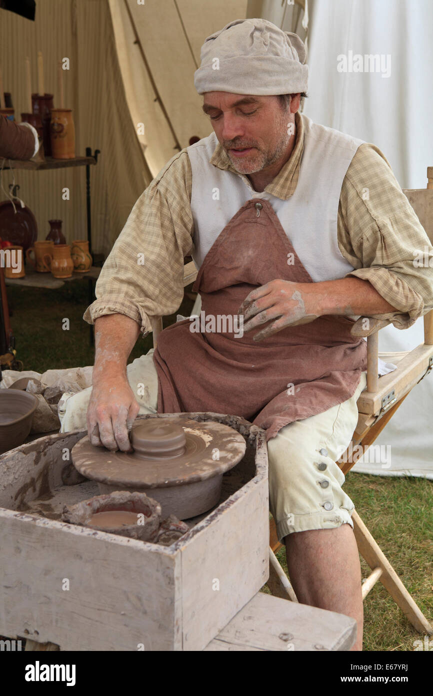 Man creating pottery with spectator in the background Stock Photo - Alamy