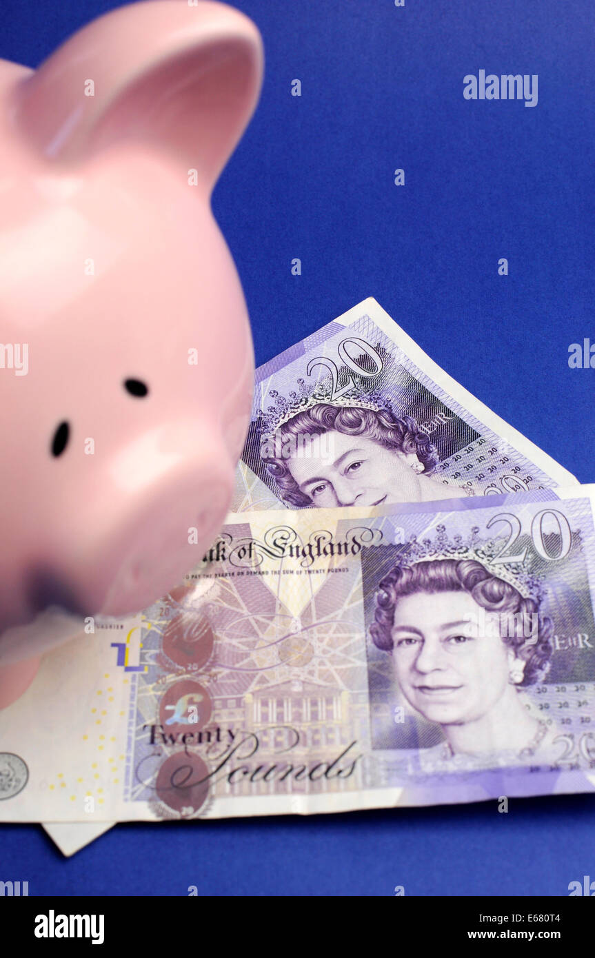 Two English Bank of England Twenty Pound notes on blue background with ...