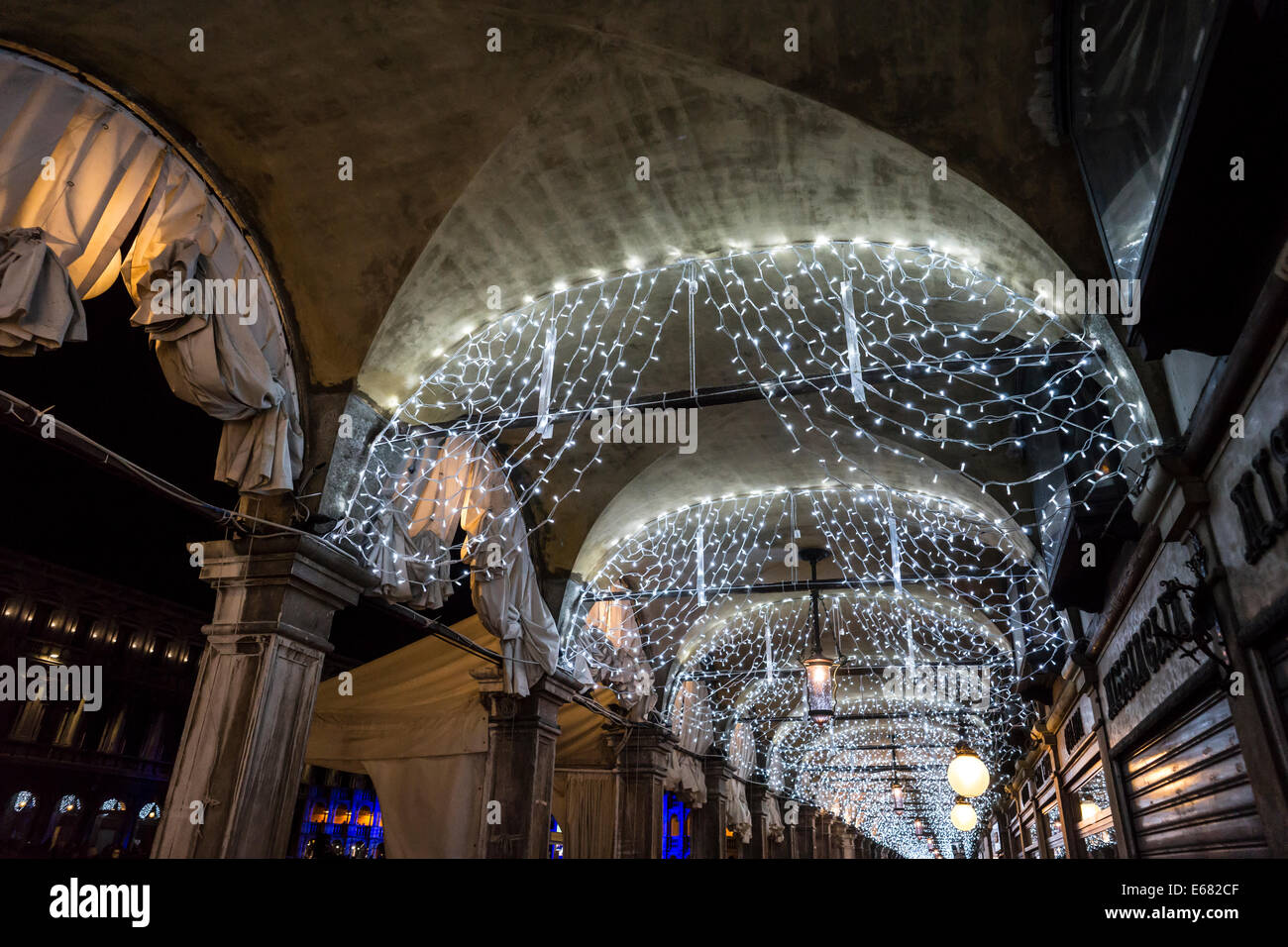 Inside the shopping colonnade of San Marco Square in Venice at night ...