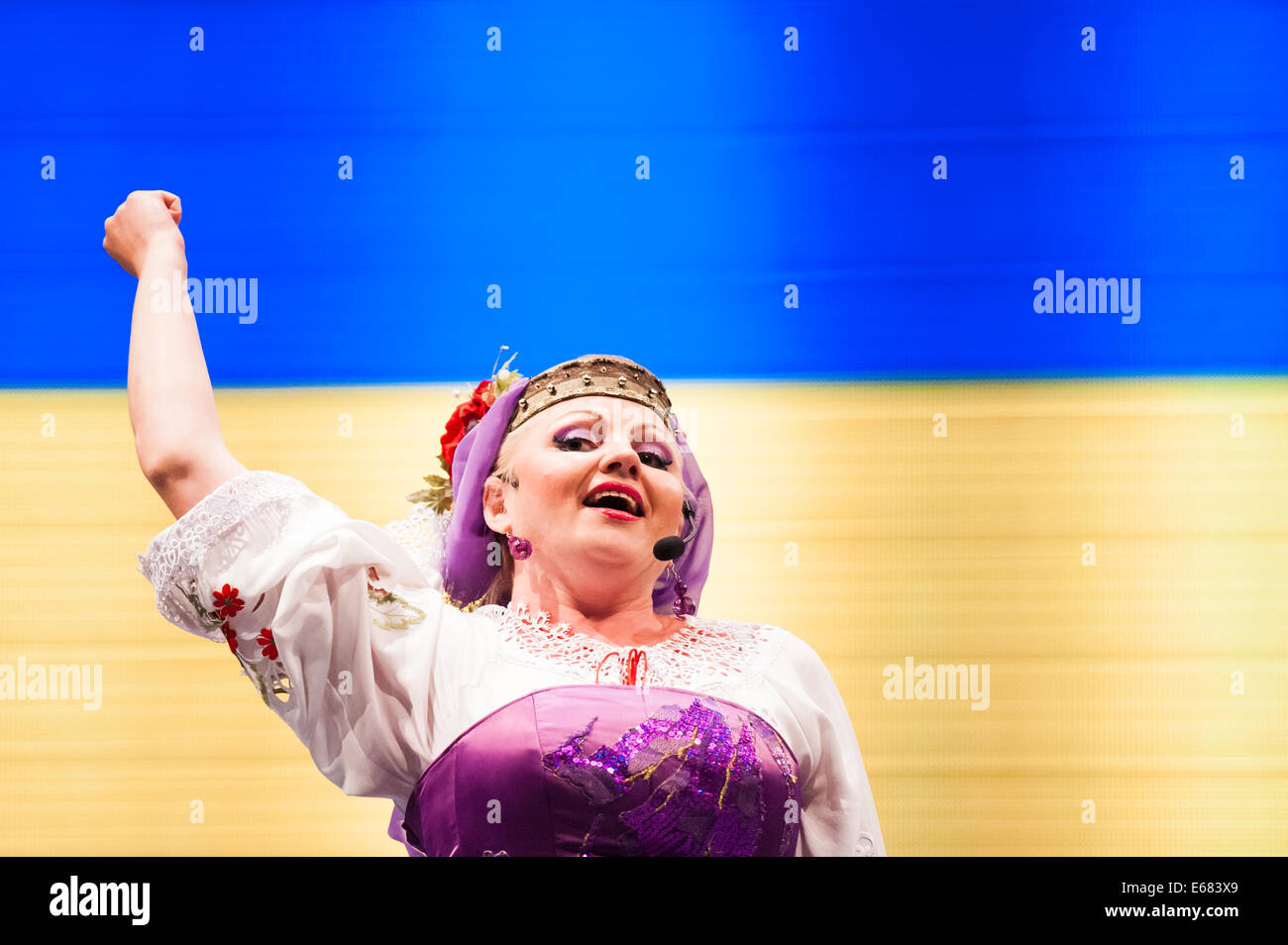 A Ukrainian woman folk singer with his right fist in the air, with ...