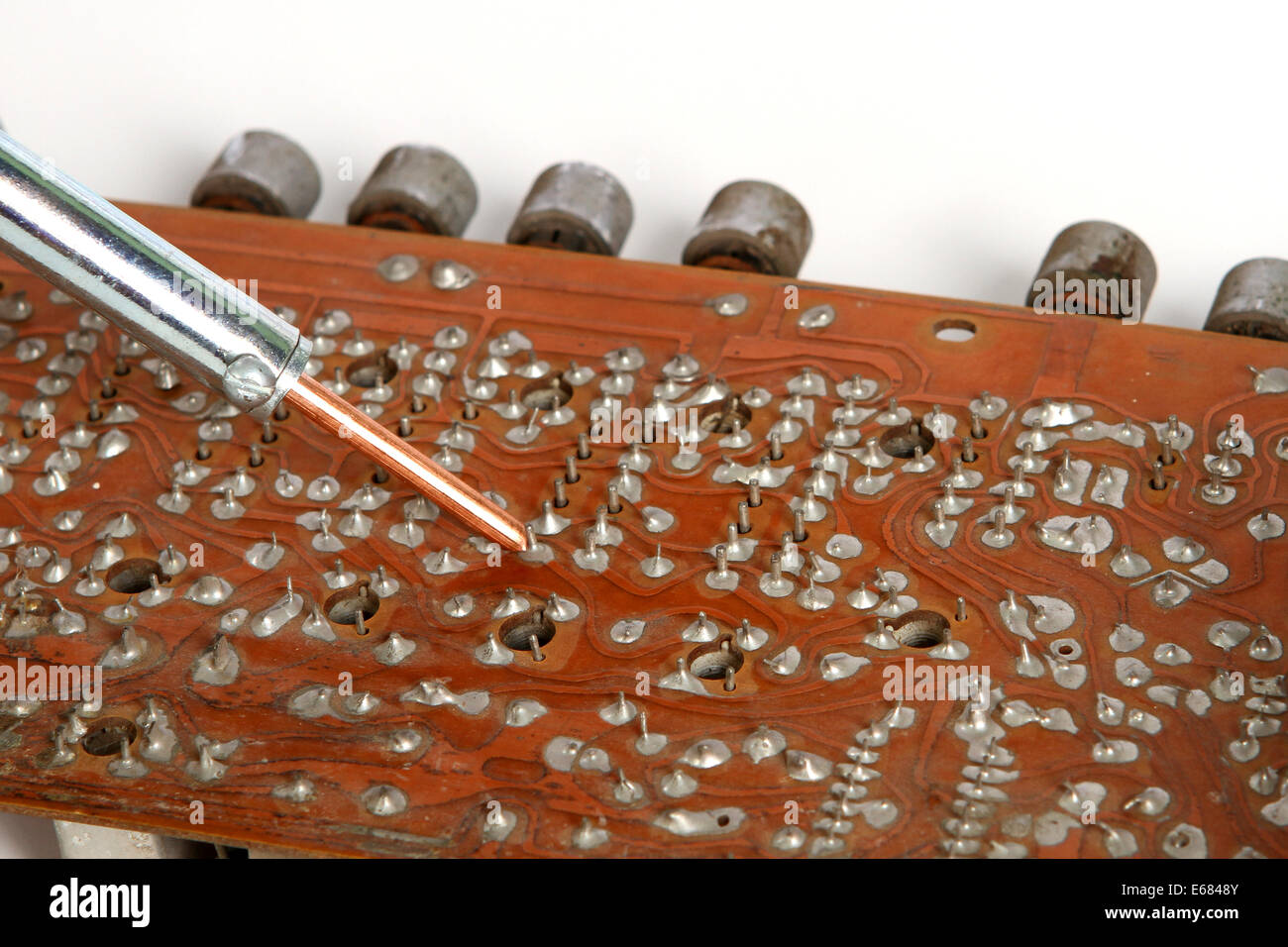 soldering iron in his hand on a white background Stock Photo - Alamy