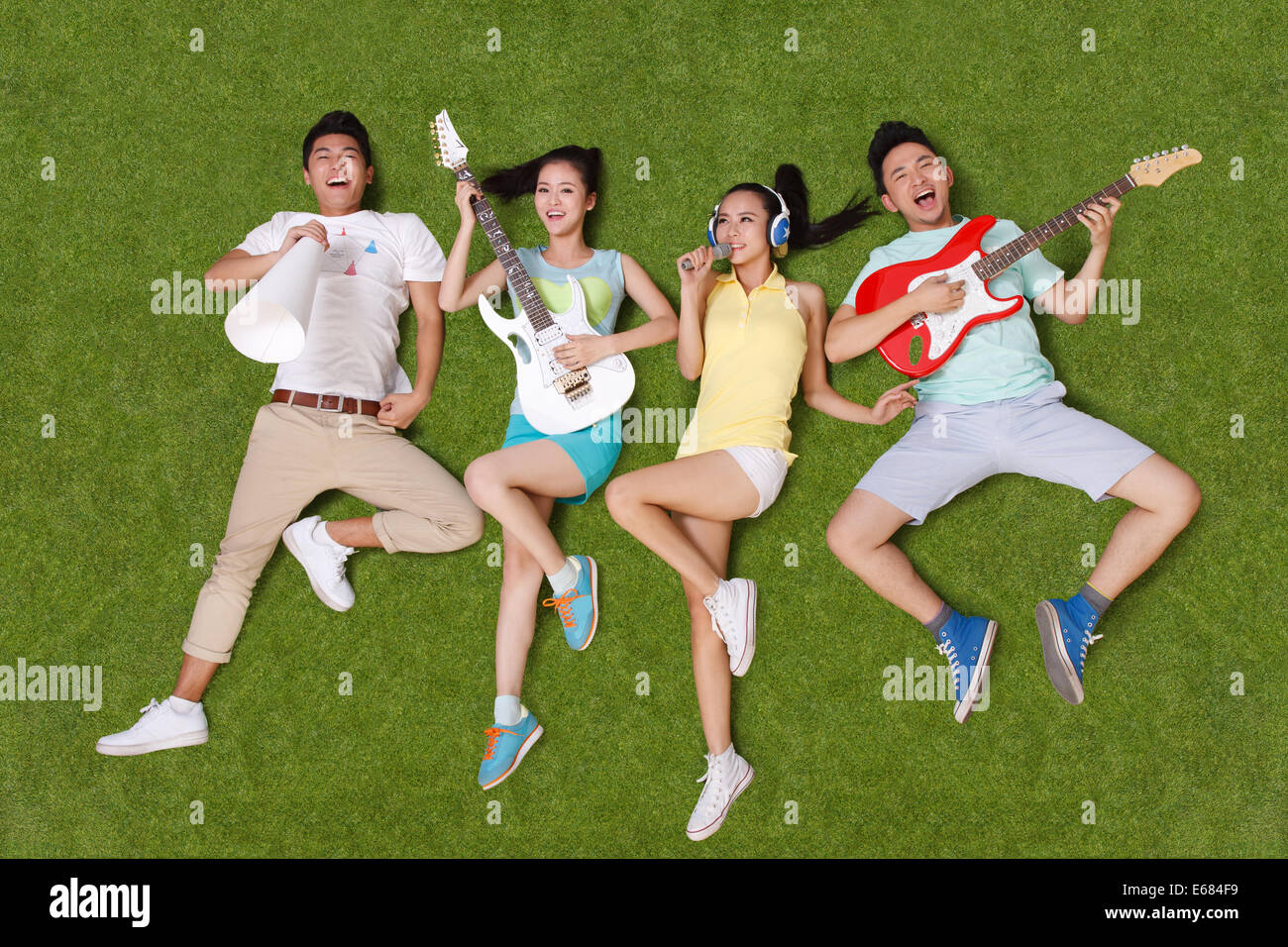 Young people on grass playing musical instruments Stock Photo - Alamy