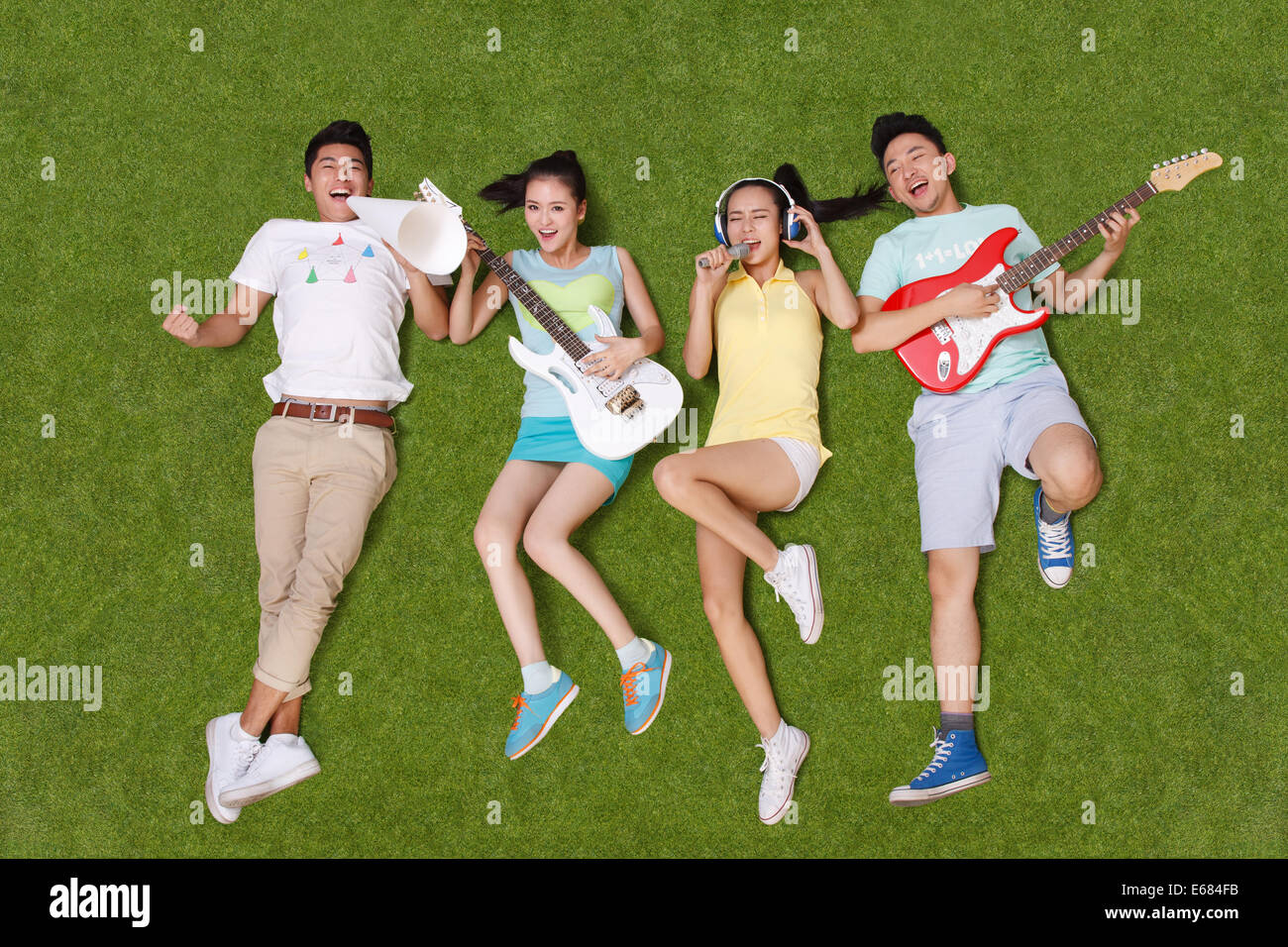 Young people on grass playing musical instruments Stock Photo - Alamy