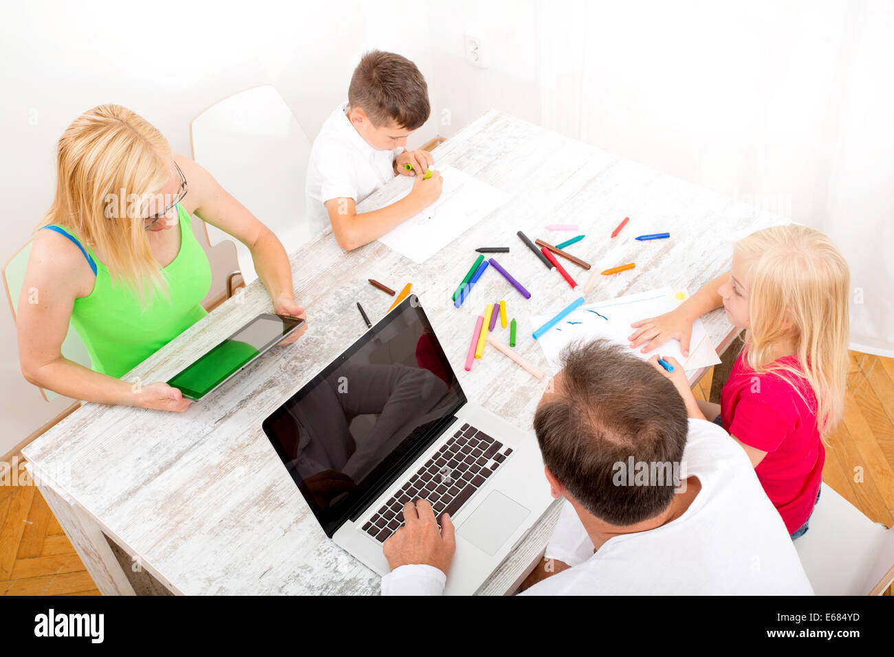 A family performing various activities at home Stock Photo - Alamy