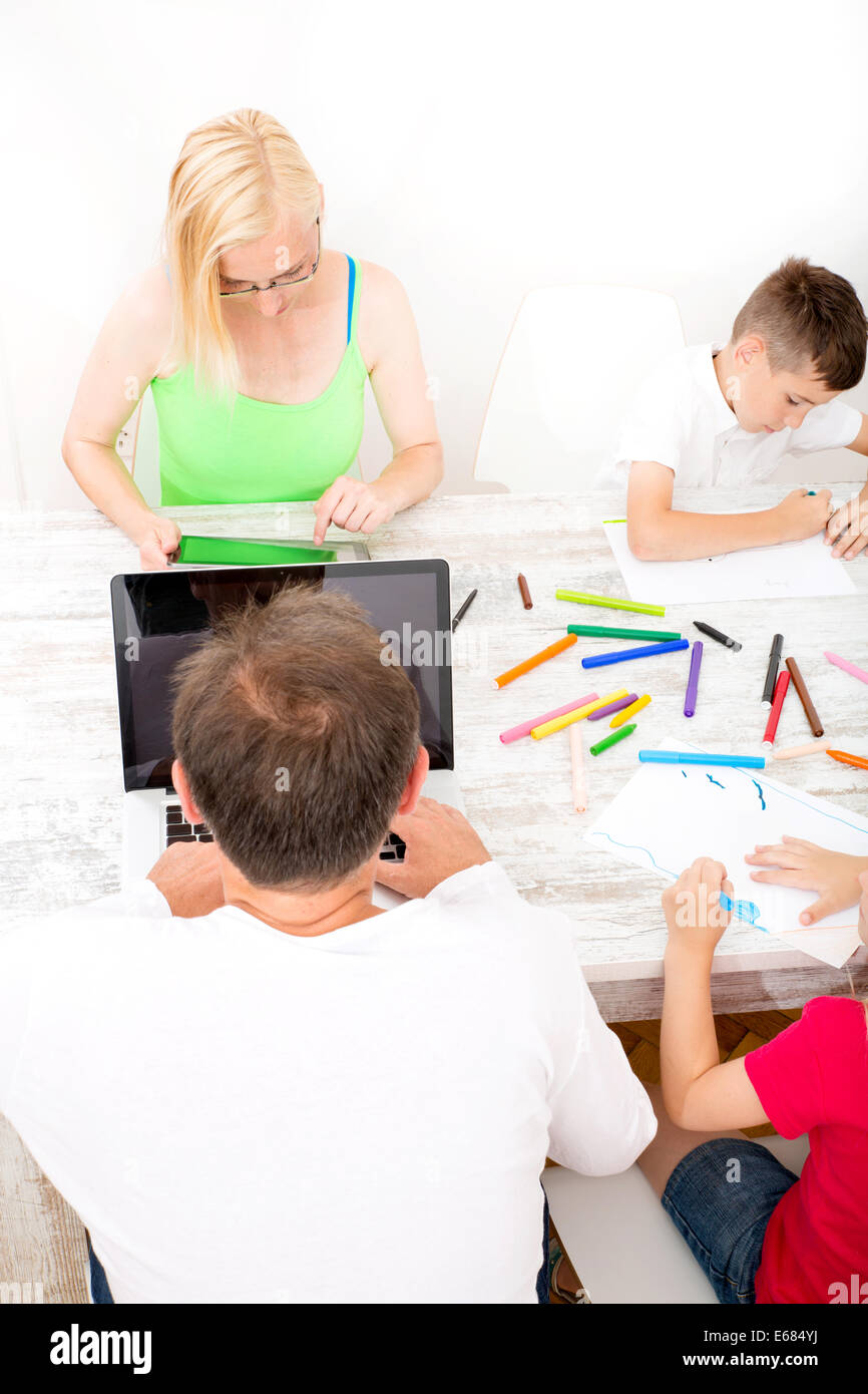 A family performing various activities at home Stock Photo - Alamy