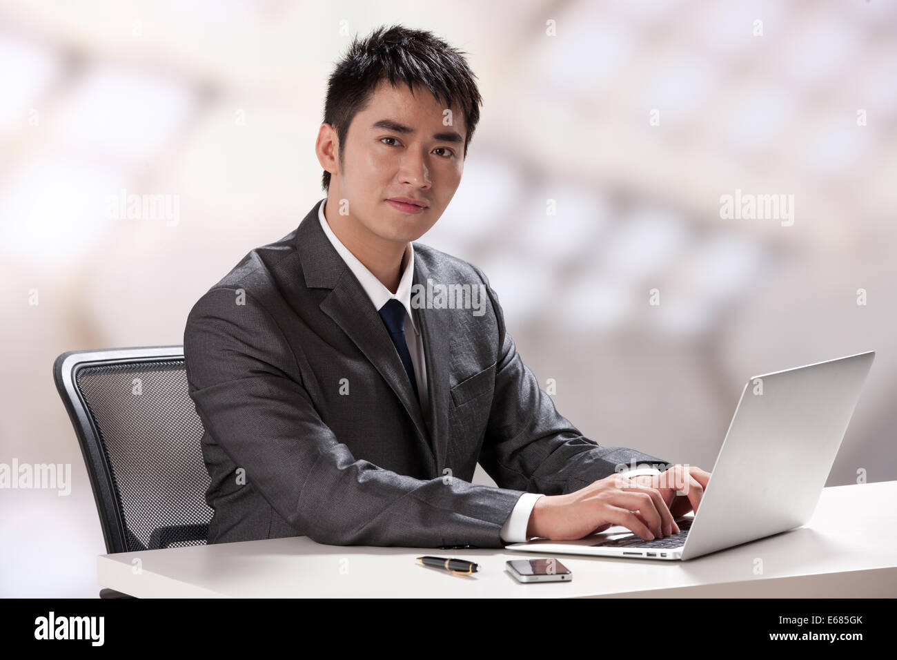 Young businessman using laptop Stock Photo - Alamy