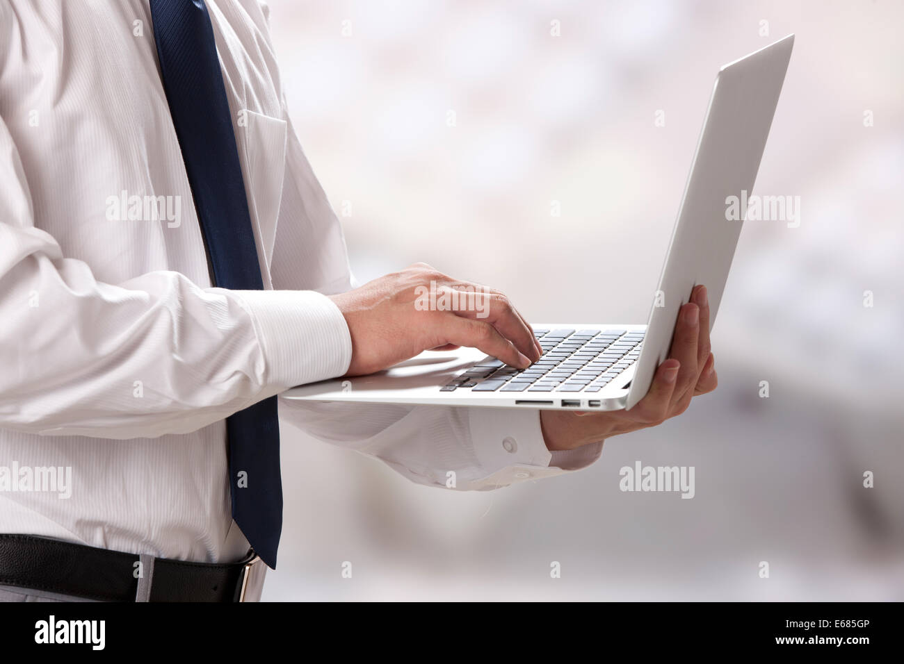 Young businessman using laptop Stock Photo - Alamy