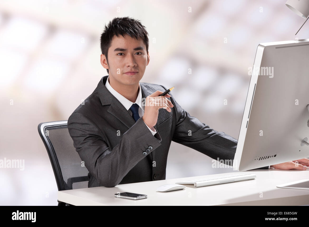 Young businessman using laptop Stock Photo - Alamy