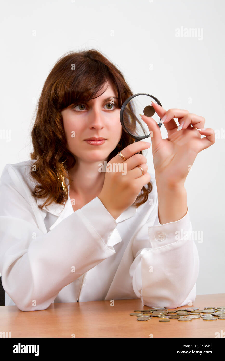 Financial concept, hand hold magnifying glass and coins Stock Photo - Alamy