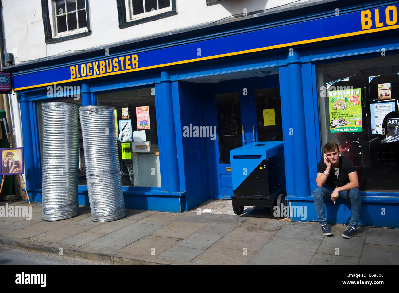 Street performers in flexible tubes entertain people outside former ...