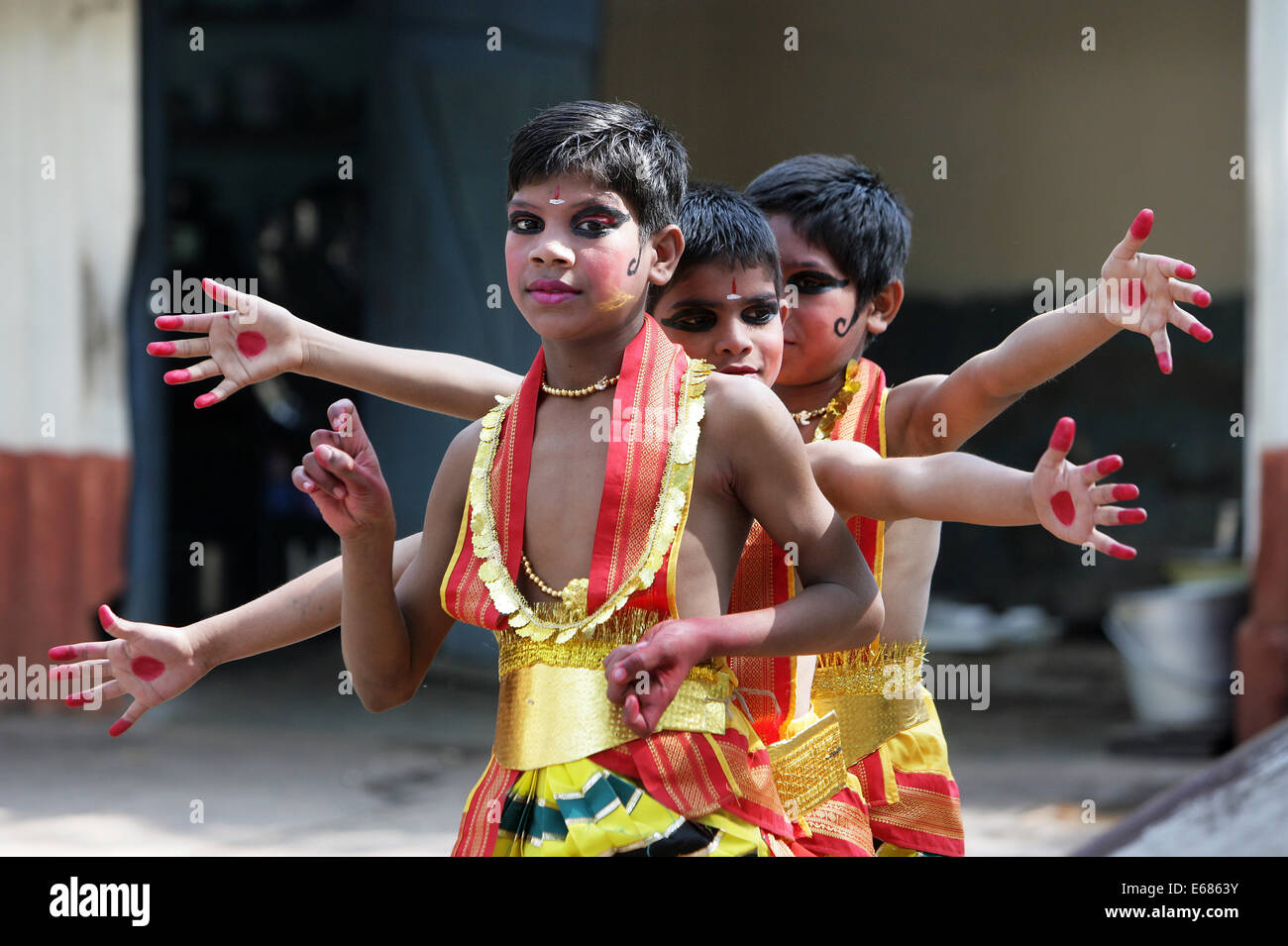 three boys in a center for homeless children perform a traditional ...