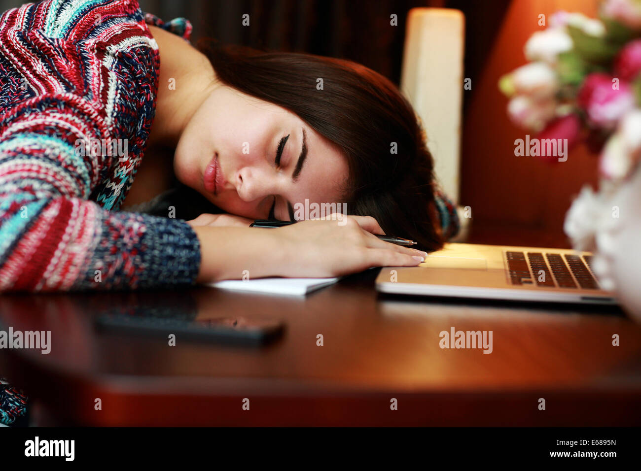 Tired woman sleeping on the table at home Stock Photo - Alamy
