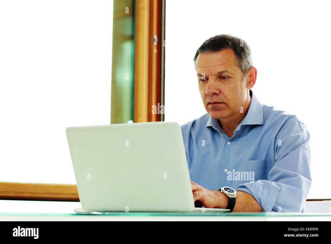 Portrait of a middle aged caucasian man looking at his laptop computer ...