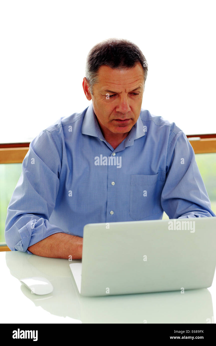 Portrait of a middle aged caucasian man looking at his laptop computer ...
