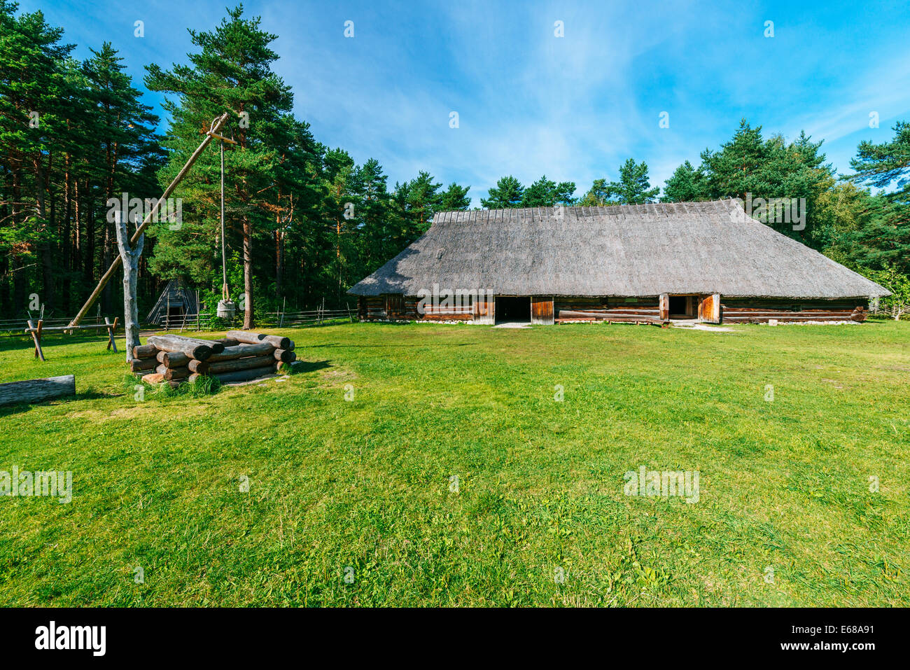 Traditional wooden hut and well Stock Photo - Alamy