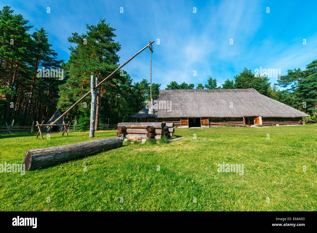 Traditional wooden hut and well Stock Photo - Alamy