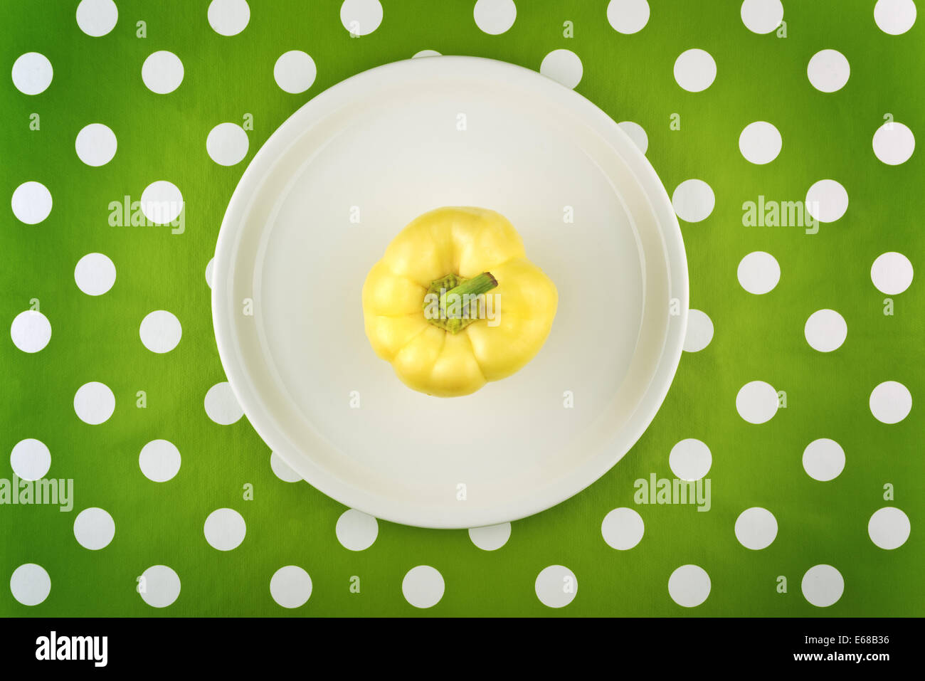 Eating fresh raw yellow pepper on a white plate, top view Stock Photo ...