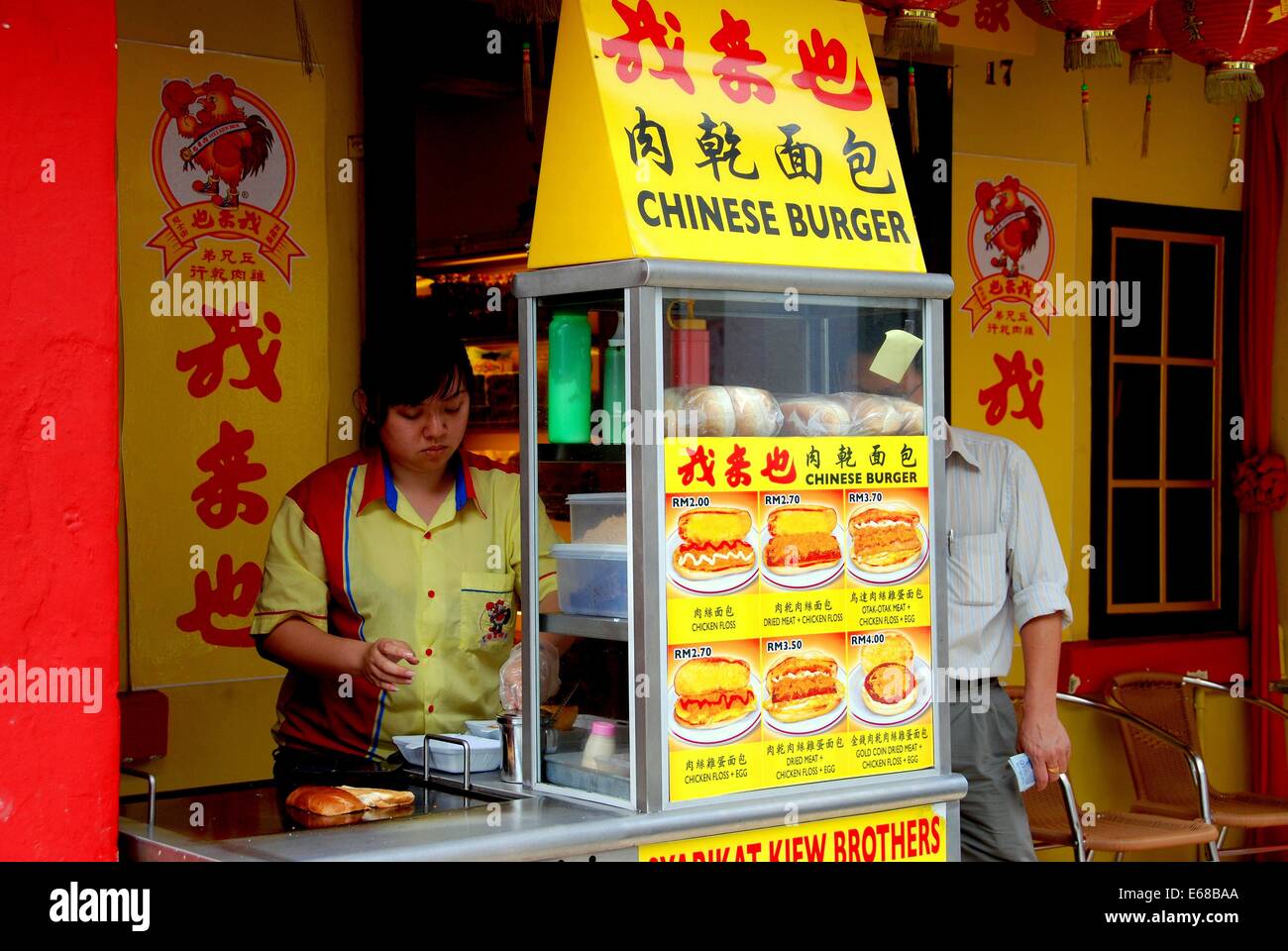 MELAKA, MALAYSIA: Vendor cart featuring several versions of a “Chinese ...