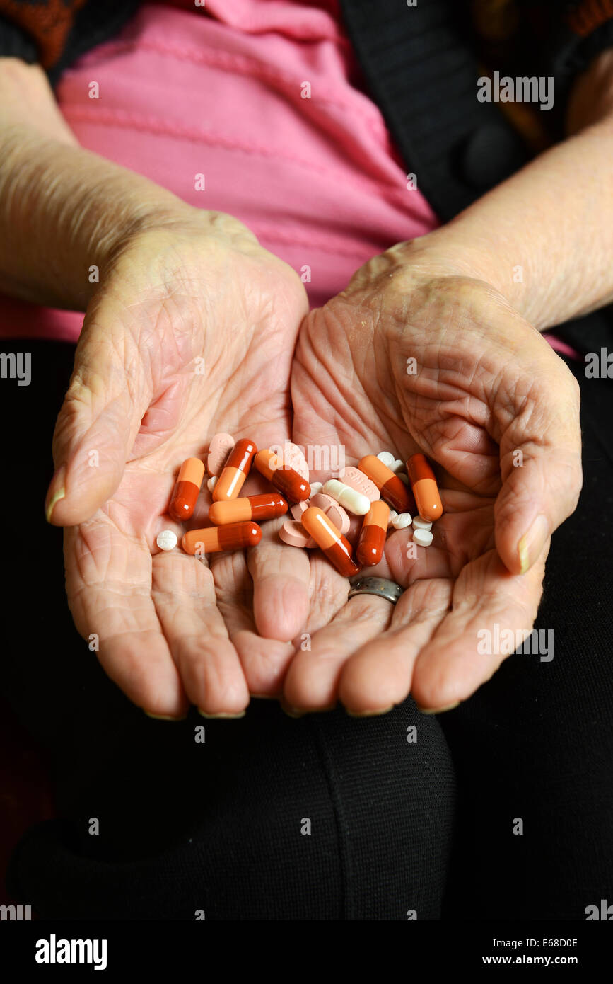 Elderly hands holding tablets, pills, medication. Old woman's hands ...