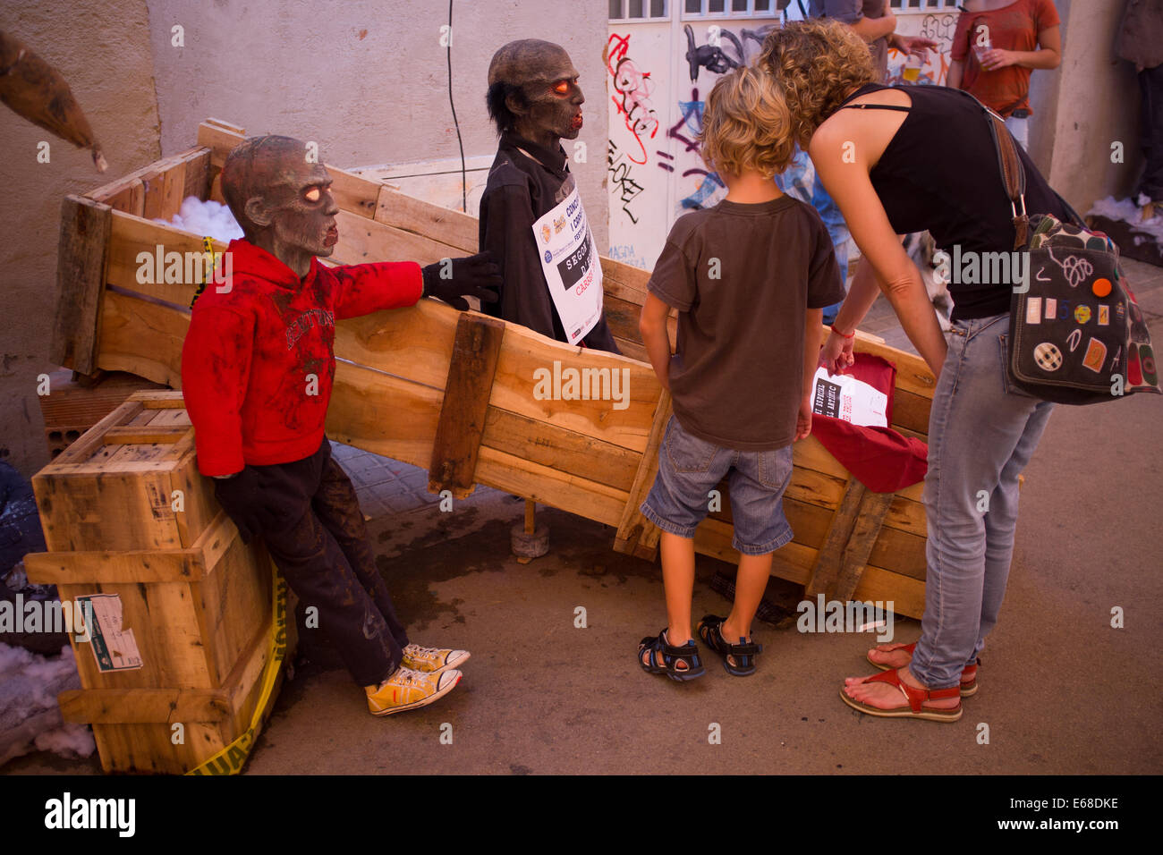 Barcelona, Spain. 18th Aug, 2014. A young zombie contemplates people ...