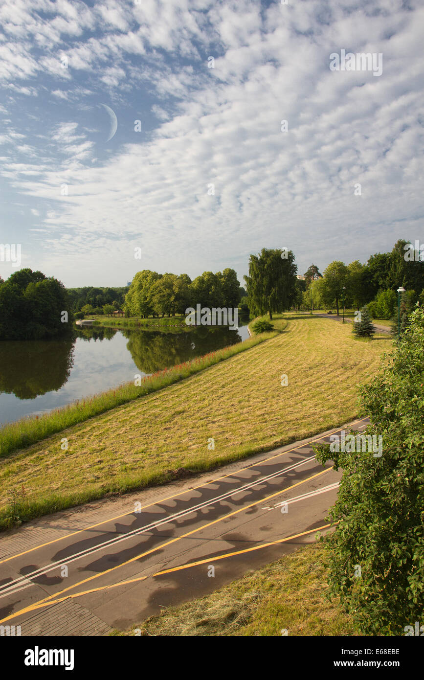 view of green fields, river and forest on background of storm clouds ...