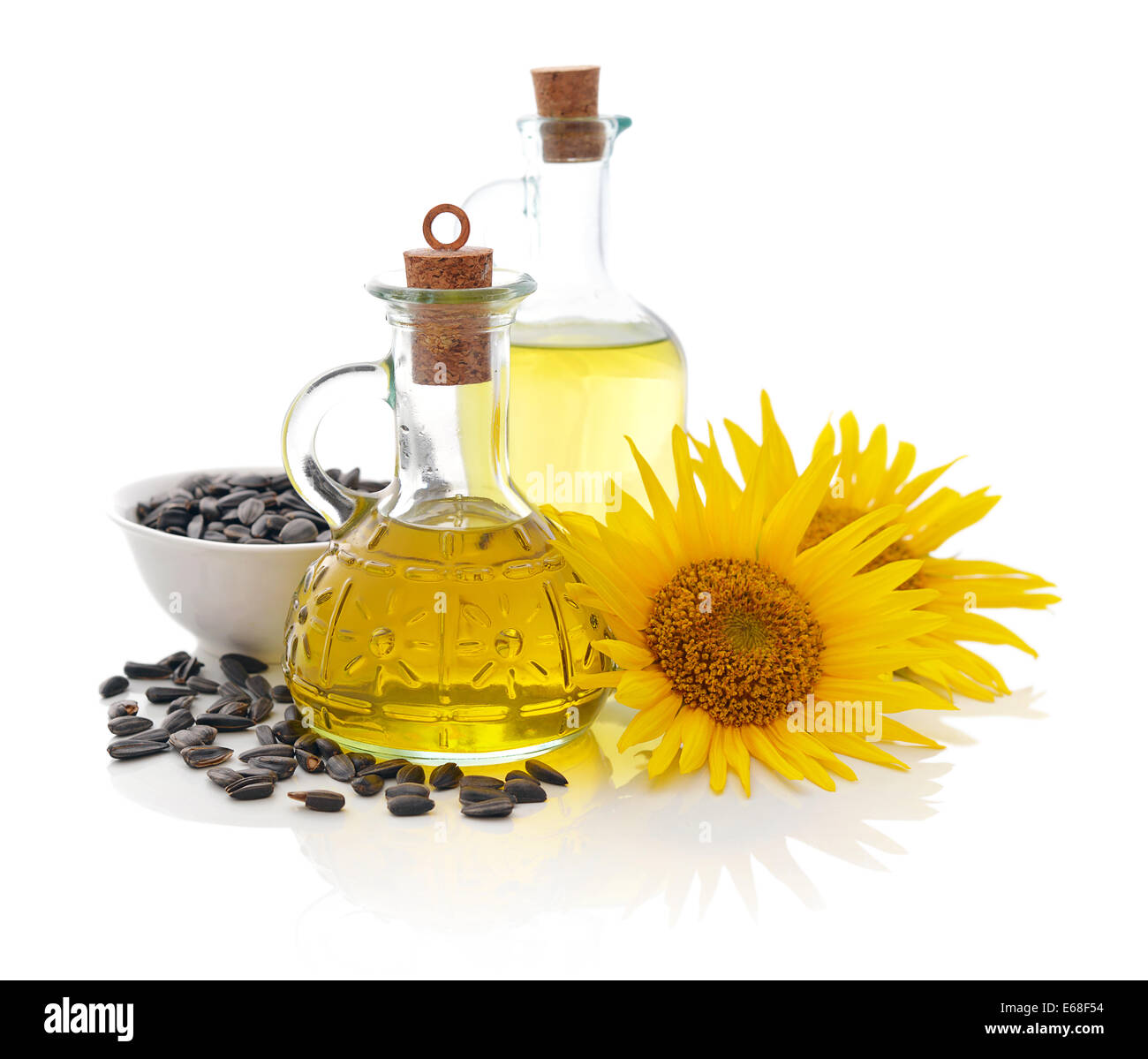 Sunflower oil in bottles with seeds and flower isolated on white ...