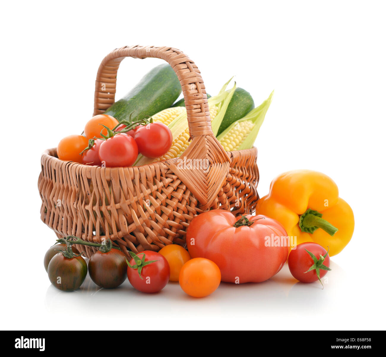 Organic vegetables in the wicker basket isolated on white background ...