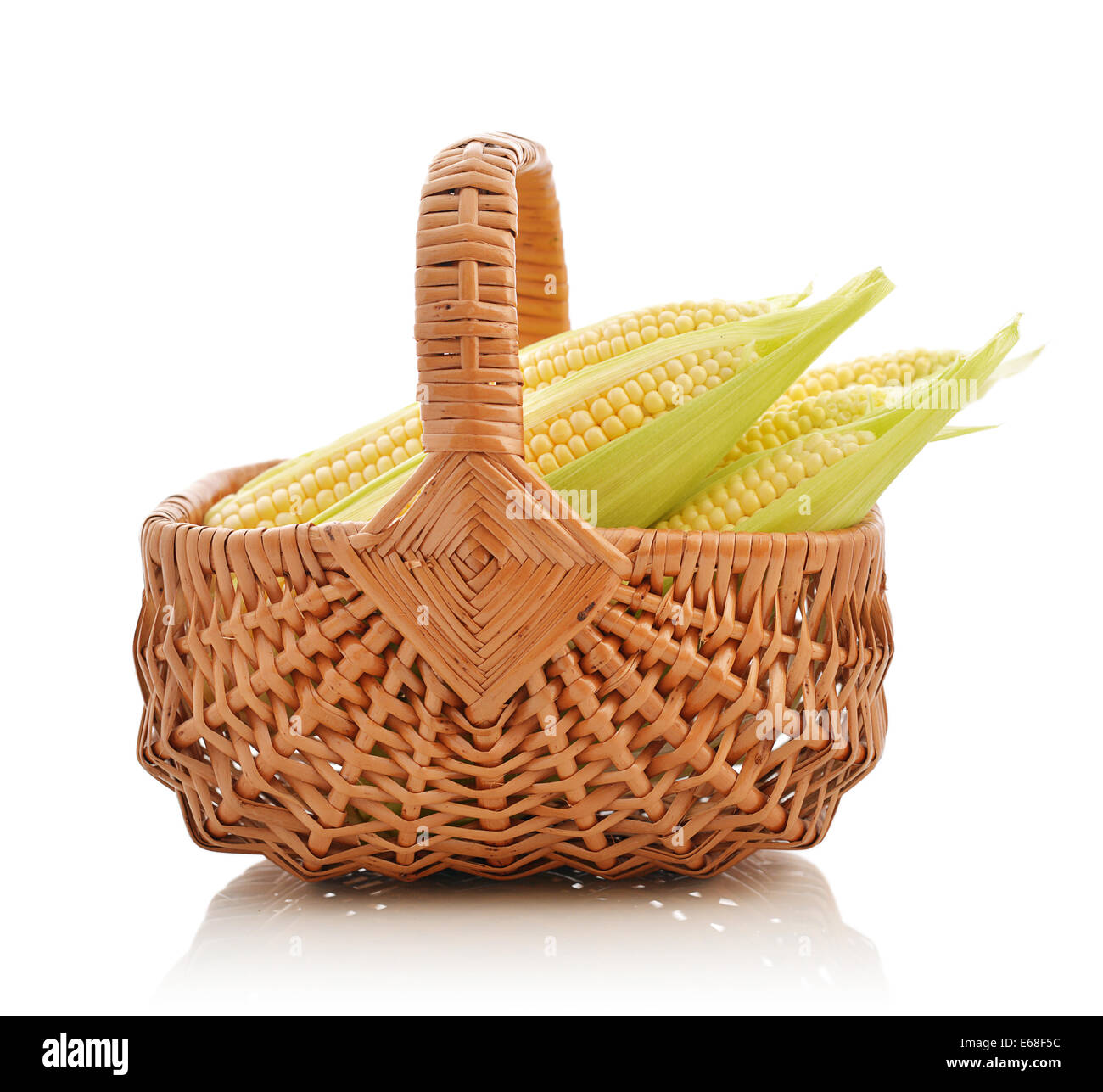 Raw corn cobs in wicker basket isolated on white background Stock Photo ...