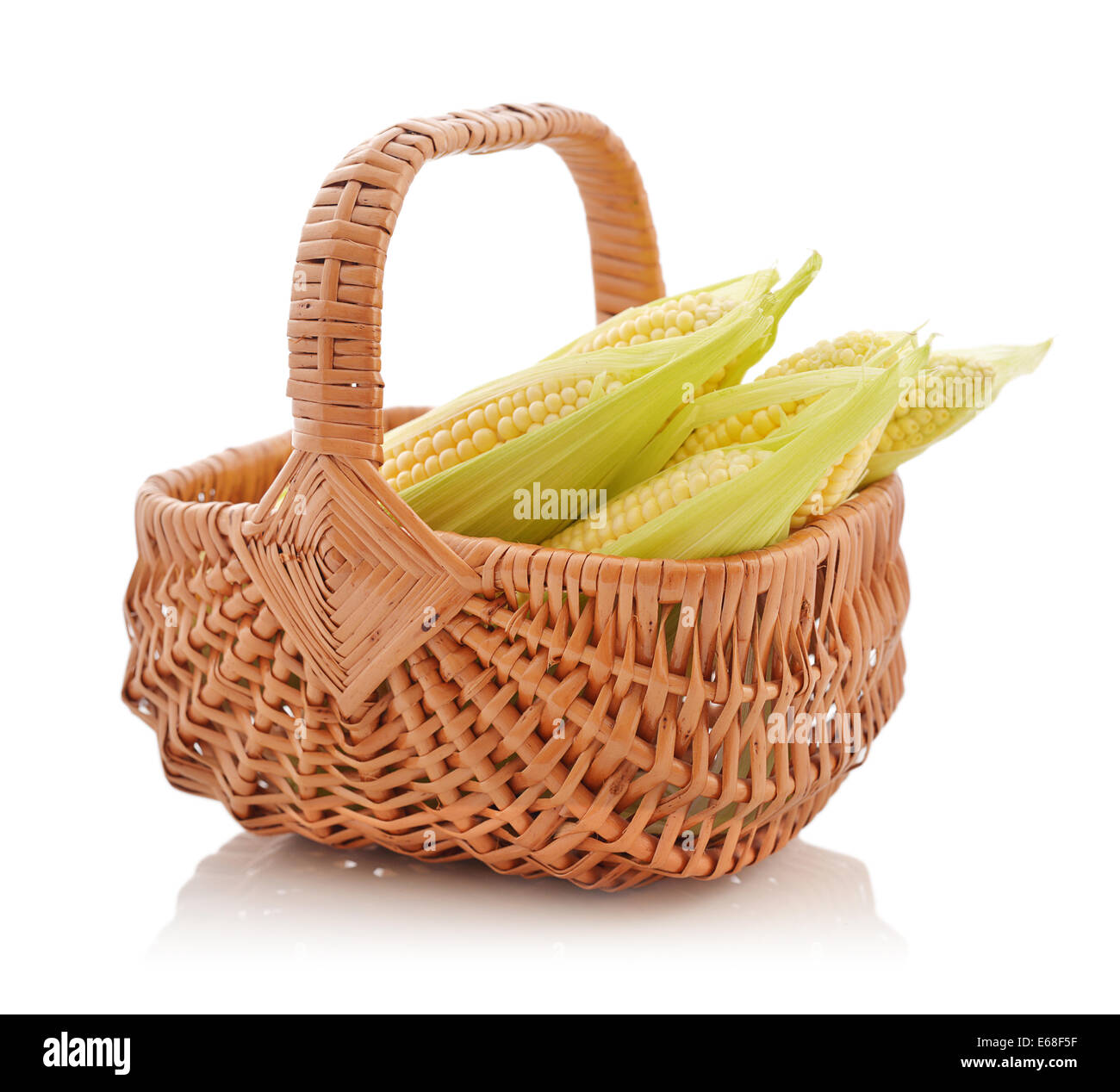 Raw corn cobs in wicker basket isolated on white background Stock Photo ...