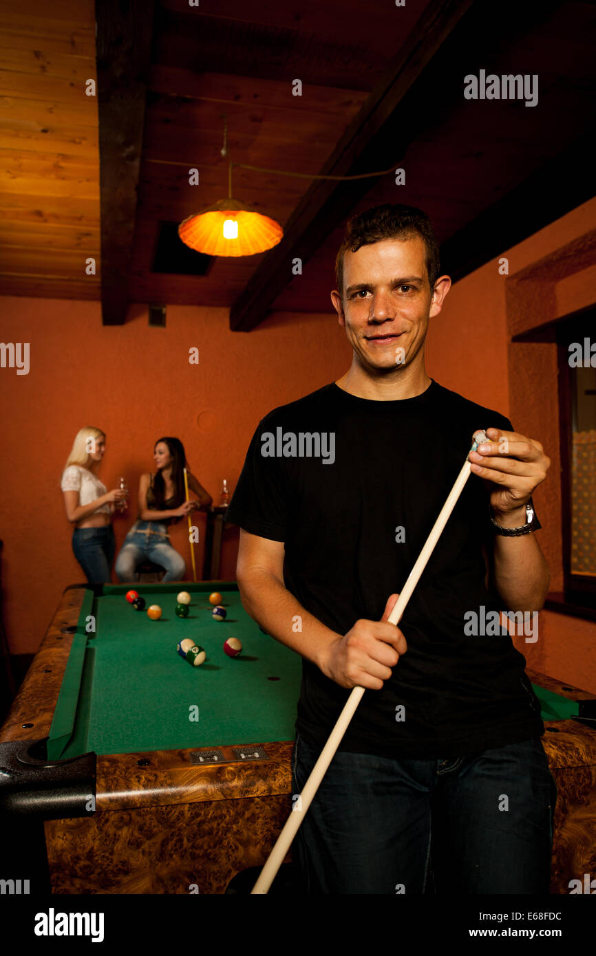 Man playing billiard in a bar at night Stock Photo - Alamy