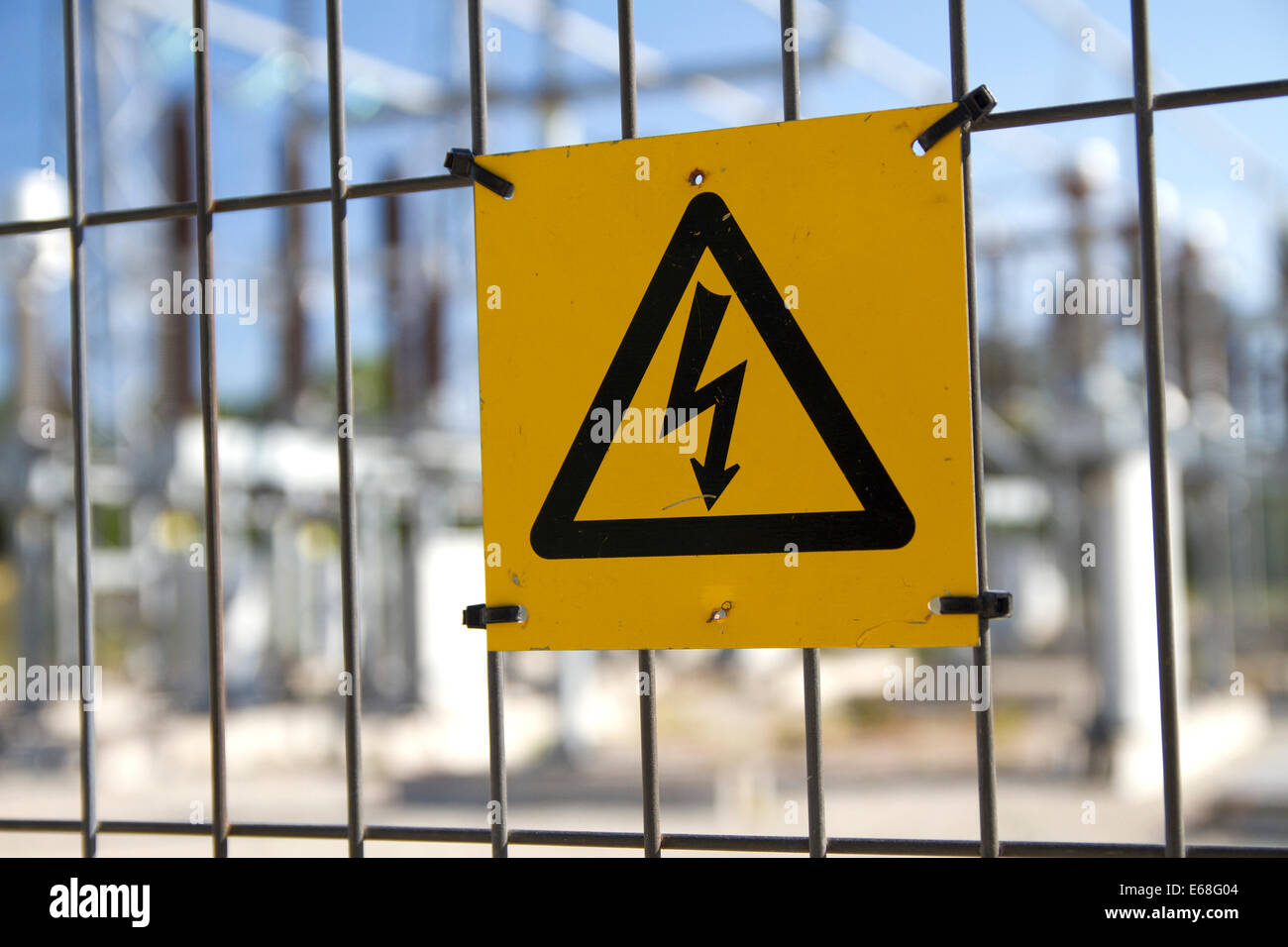 Electricity sign hanging on the fence Stock Photo - Alamy