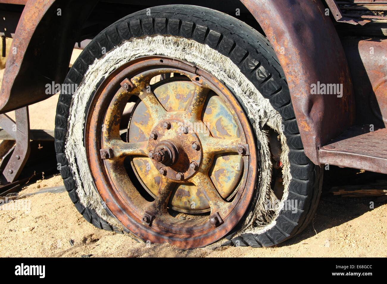 A vintage and weathered tyre wheel, showcasing signs of age and decay ...