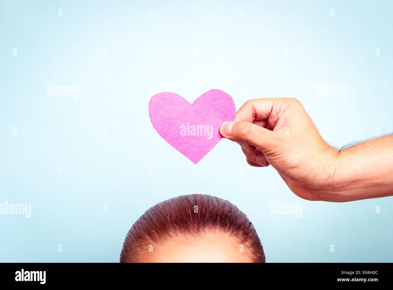 Love heart shape over top of head of woman Stock Photo - Alamy