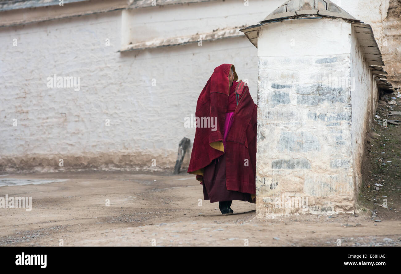 The aged Tibetan monk of Labrang Monastery is hiding from a crowd of ...