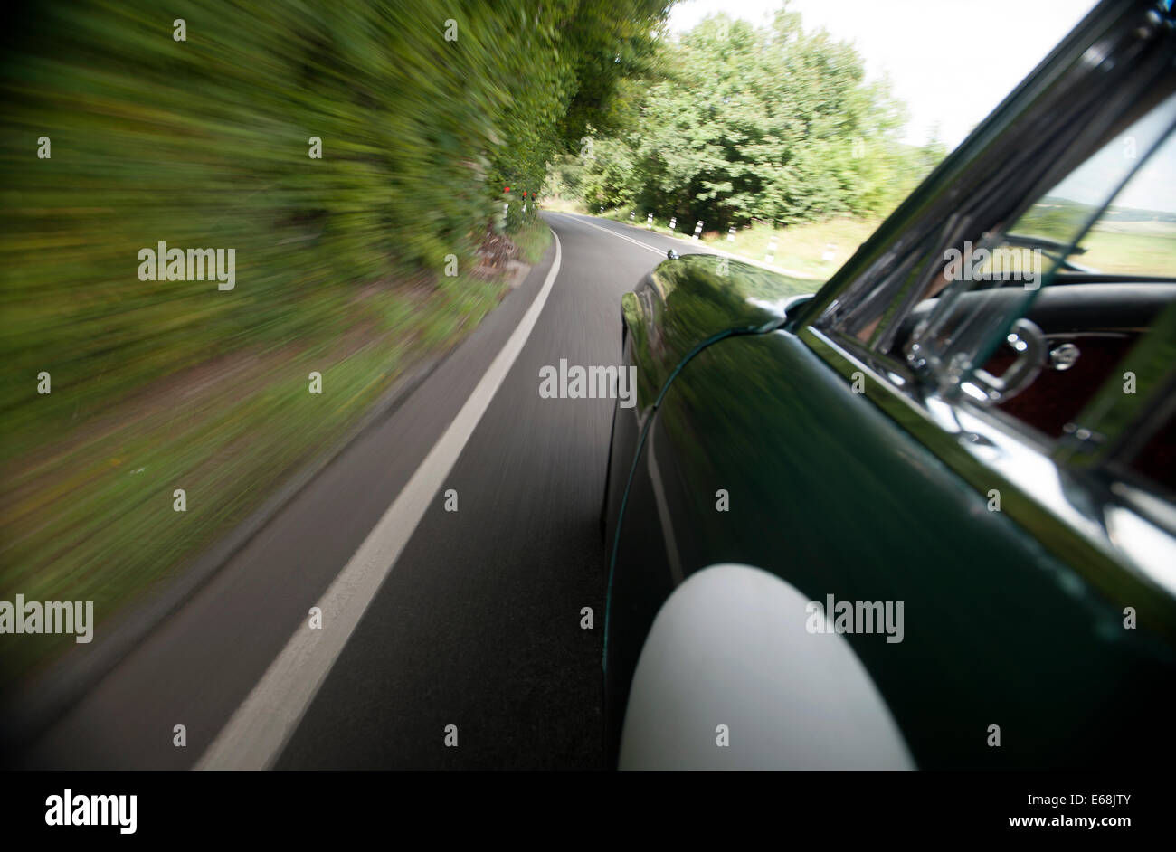 Car driving fast on country road Stock Photo - Alamy