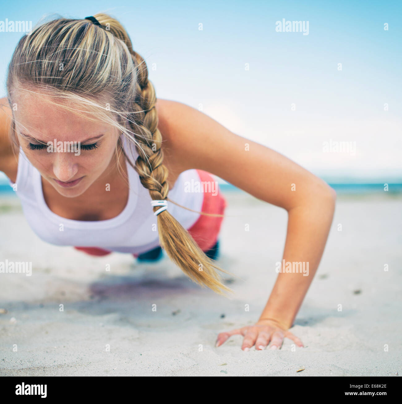 Woman doing push-ups on the beach Stock Photo - Alamy