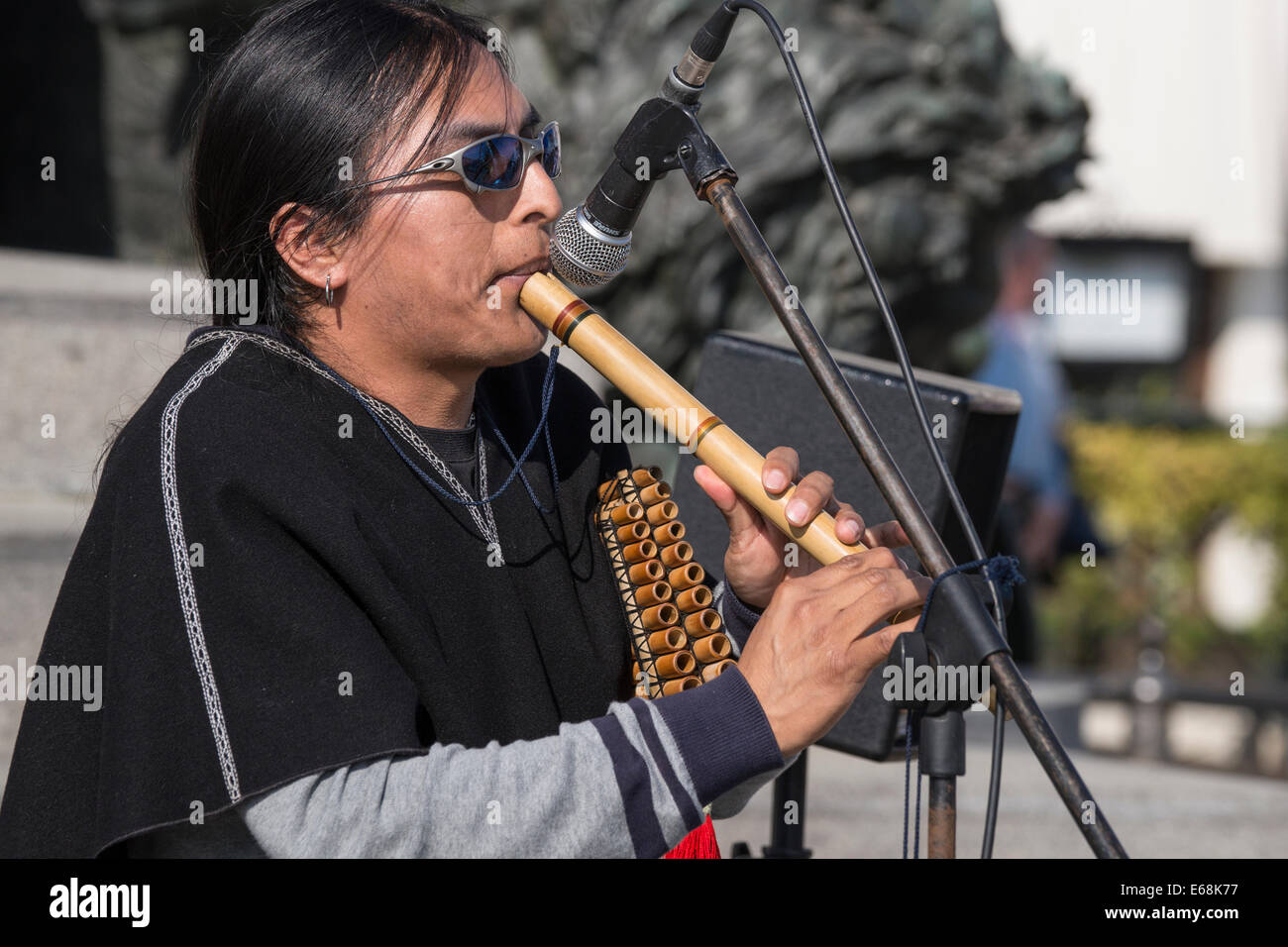 Andean flute player performs for Carnival crowds on the waterfront in ...