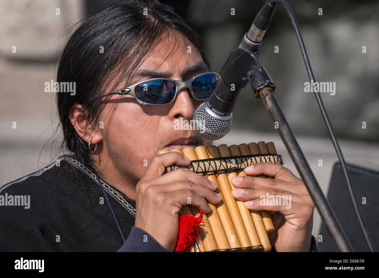 Closeup of Andean flute player performs for Carnival crowds on the ...