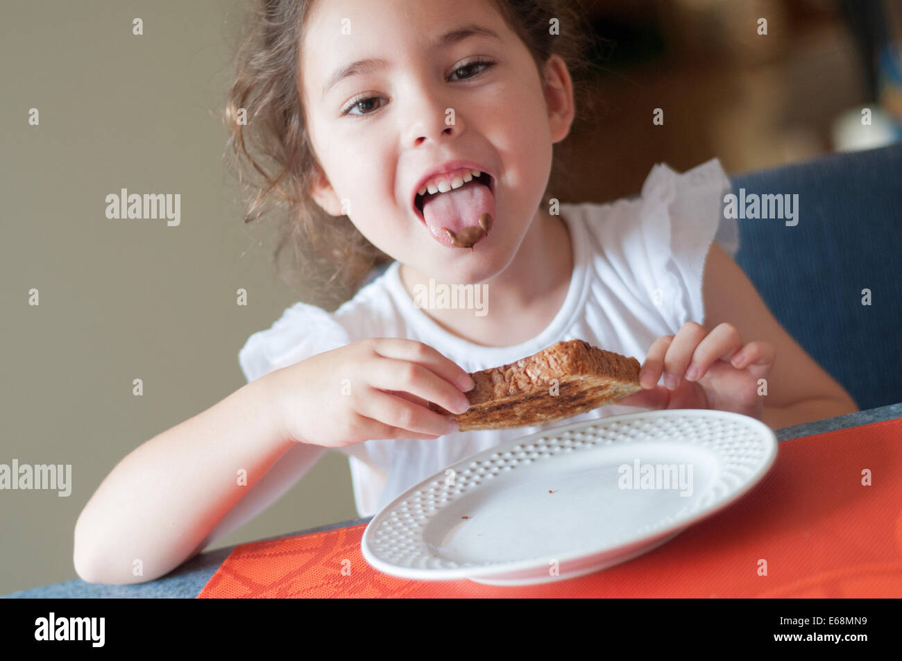 Child eating bread with chocolate spread Stock Photo - Alamy