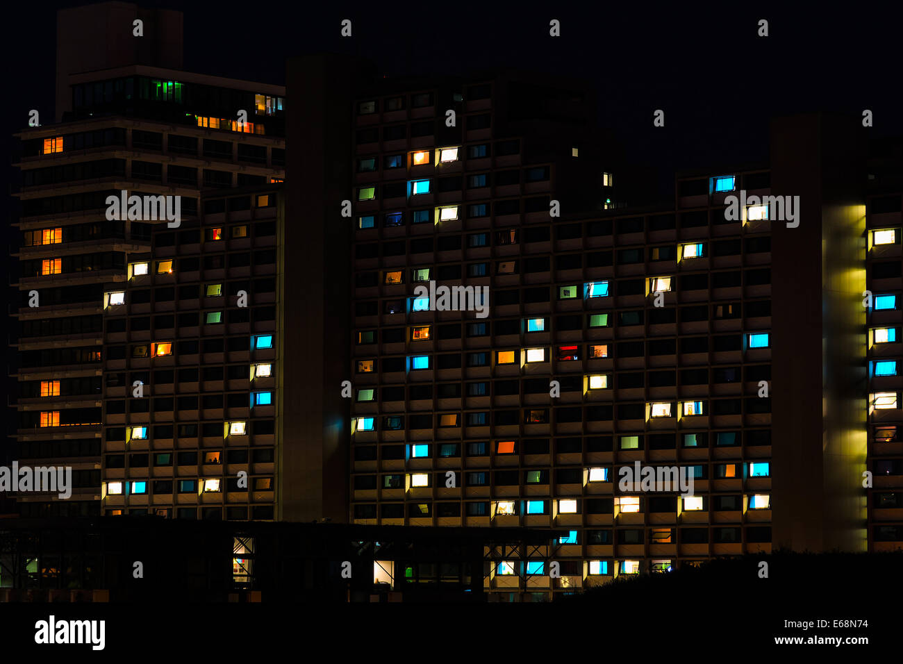 Night colorful windows lights of the high-rise residential building in ...