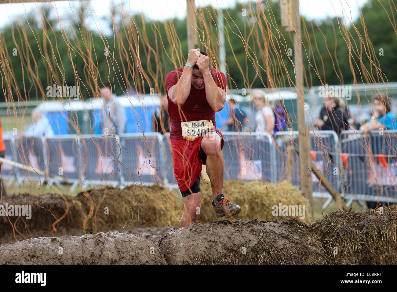 A Tough Mudder tackling the Shock Therapy obstacle Stock Photo - Alamy