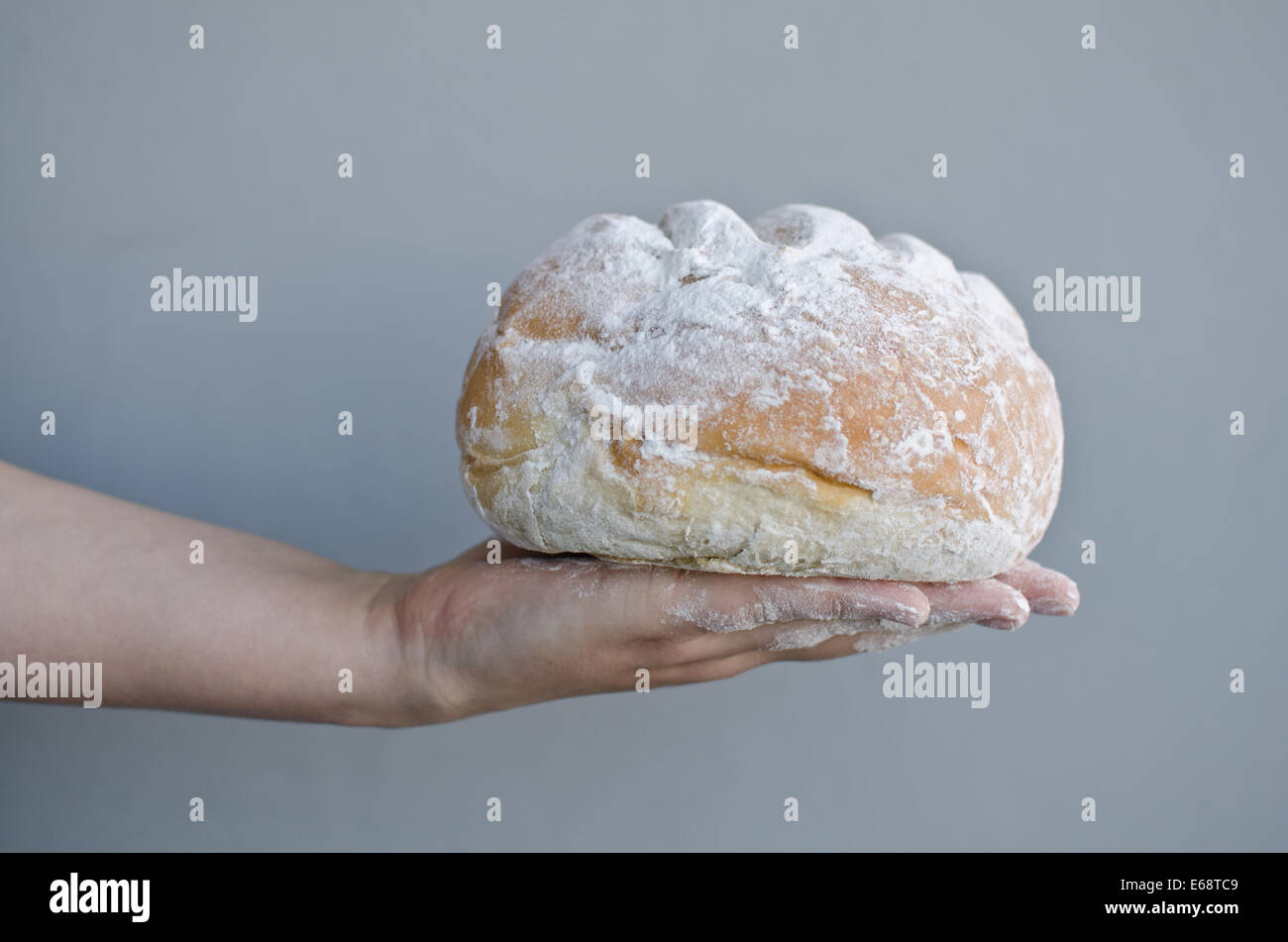 Hands holding homemade country bread Stock Photo - Alamy